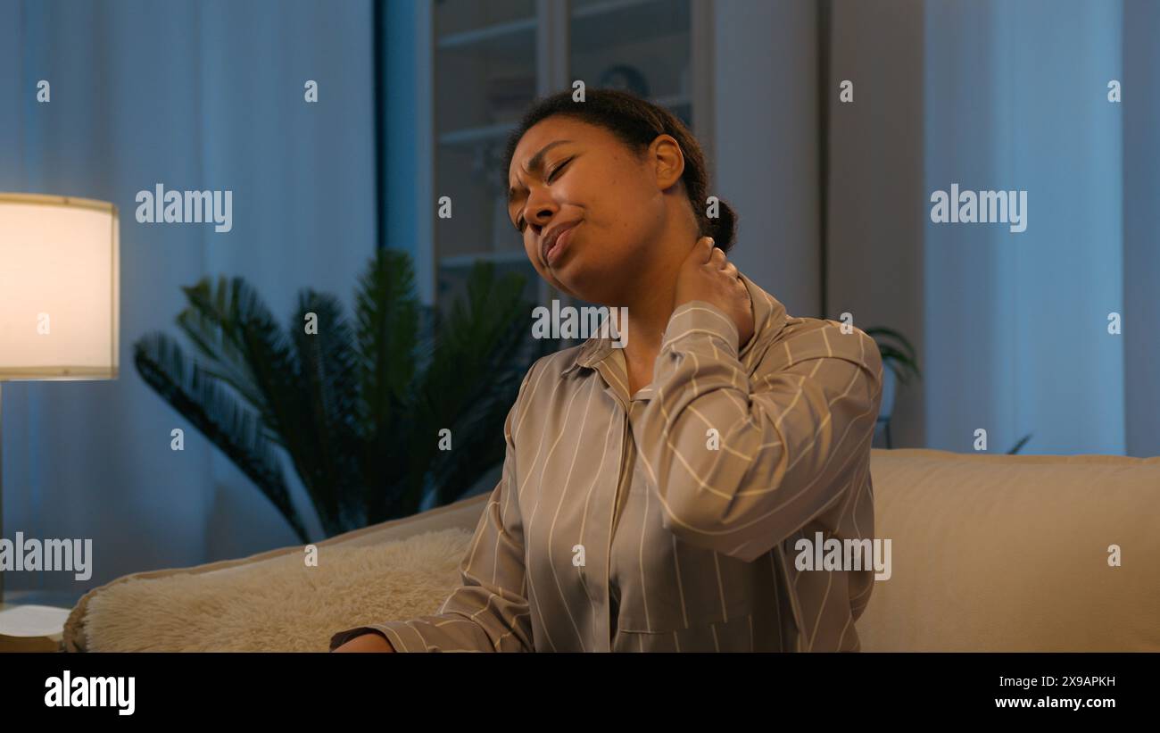 Sick exhausted African American unwell woman feel pain in neck spinal ...