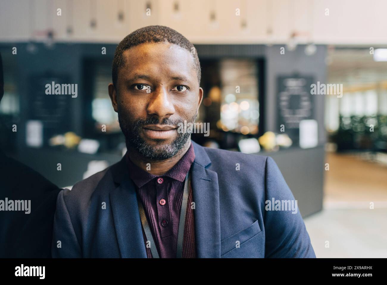 Portrait of male entrepreneur at networking event in convention center ...