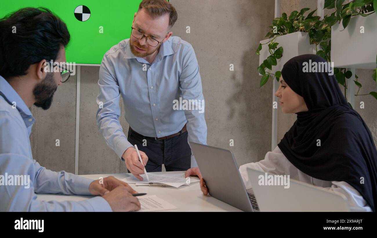 Multiethnic colleagues businessmen and muslim businesswoman in hijab ...