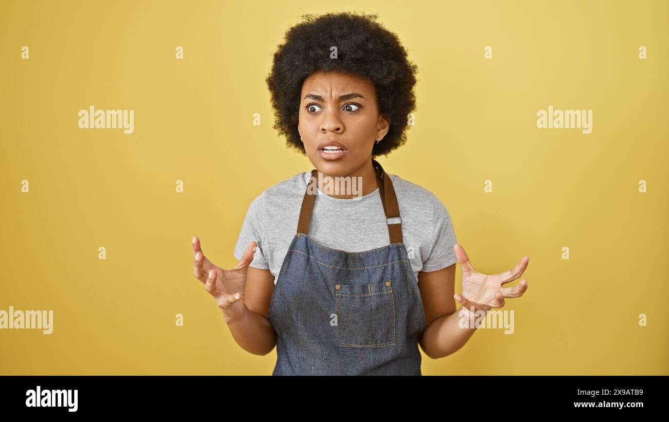 A surprised african american woman with curly hair standing against a ...