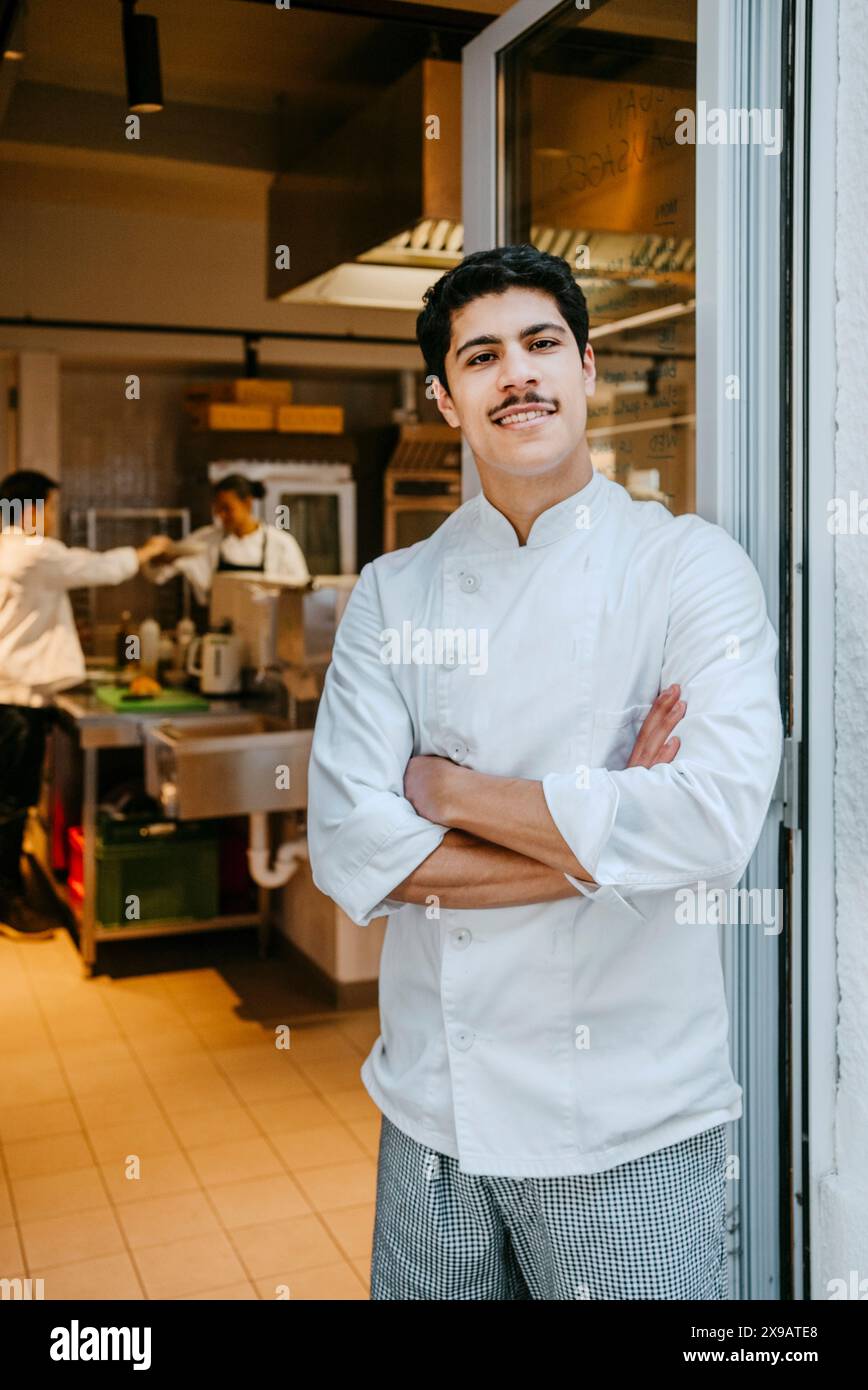 Happy chef standing arms crossed hi-res stock photography and images ...