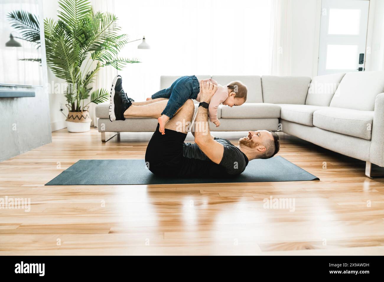 Nice father training with his baby at home Stock Photo - Alamy
