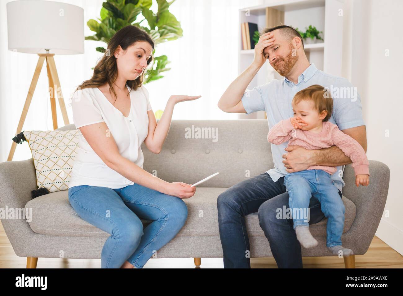 Sad Couple with pregnancy test at home interior with baby Stock Photo ...