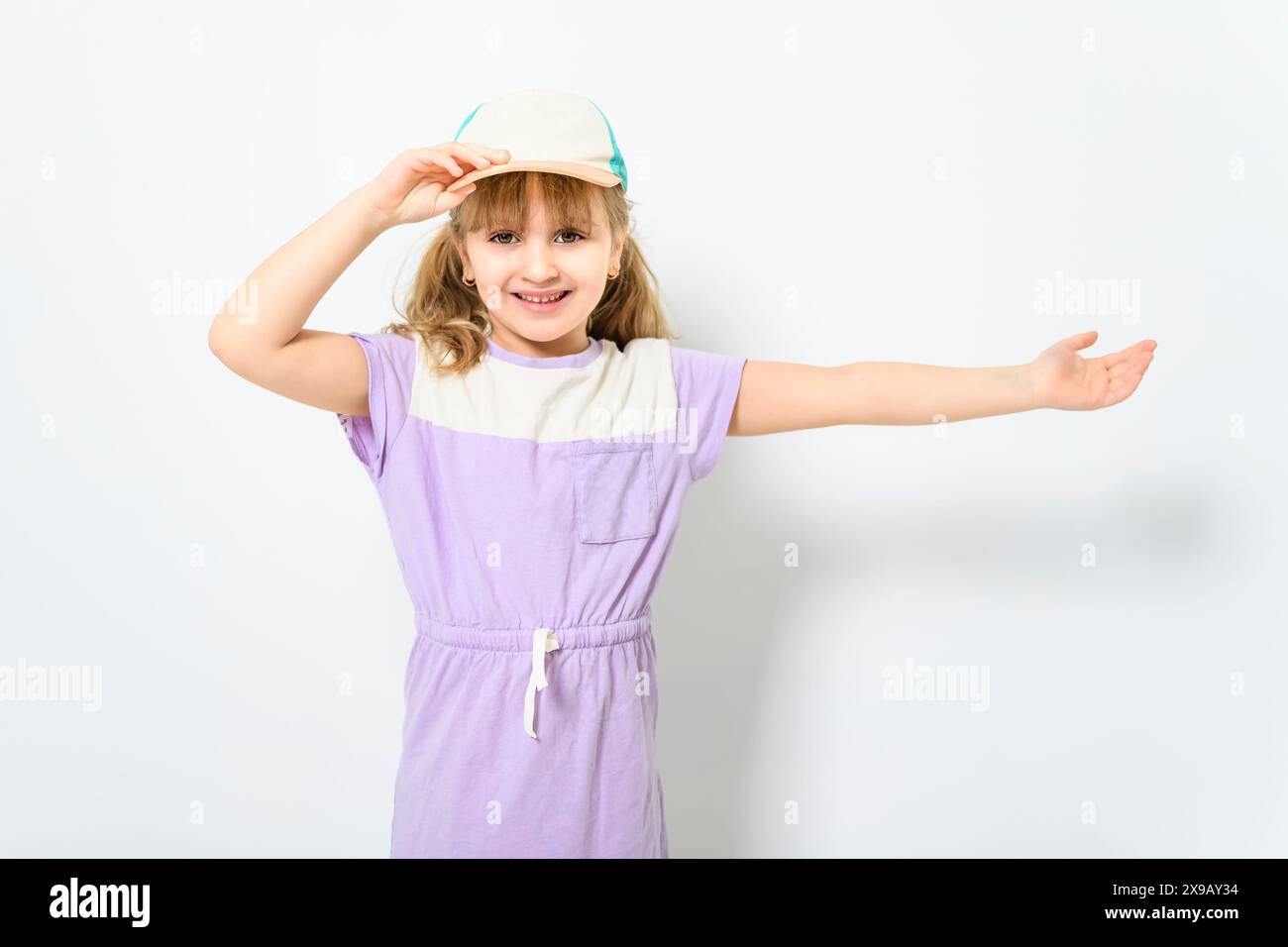Little beautiful calm girl with cap isolated on white background Stock ...