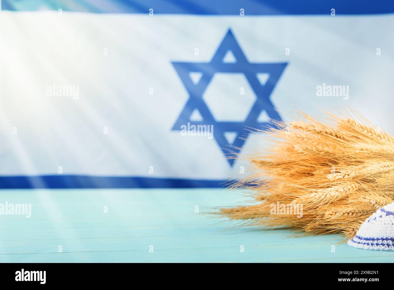 Shavuot jewish background. Ripe bouquet of wheat with blue ribbon ...