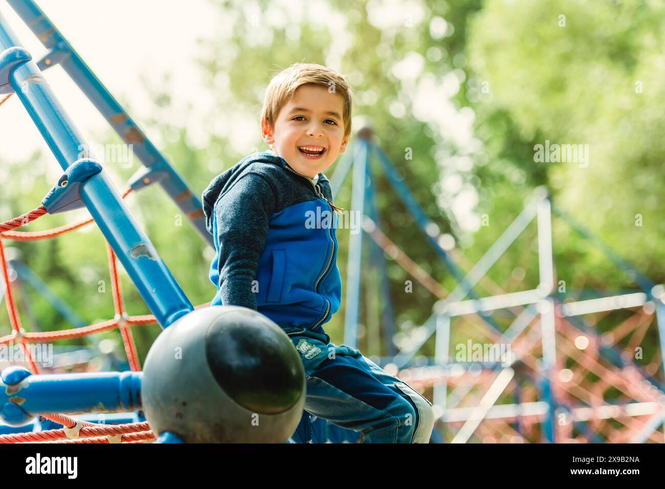 cute boy having fun on a playground Stock Photo - Alamy