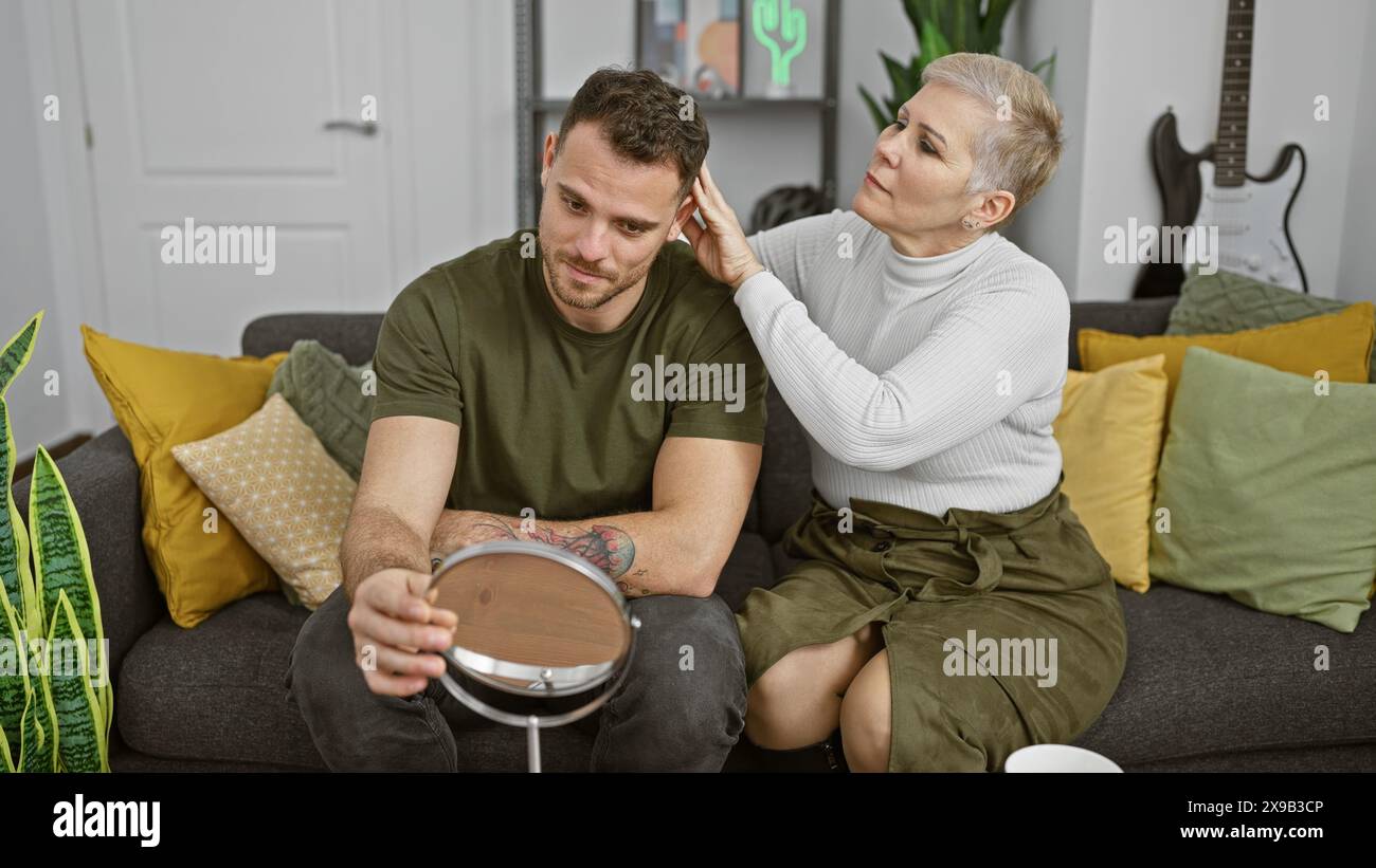 A woman comforts a man with a handheld mirror at their cozy, well ...