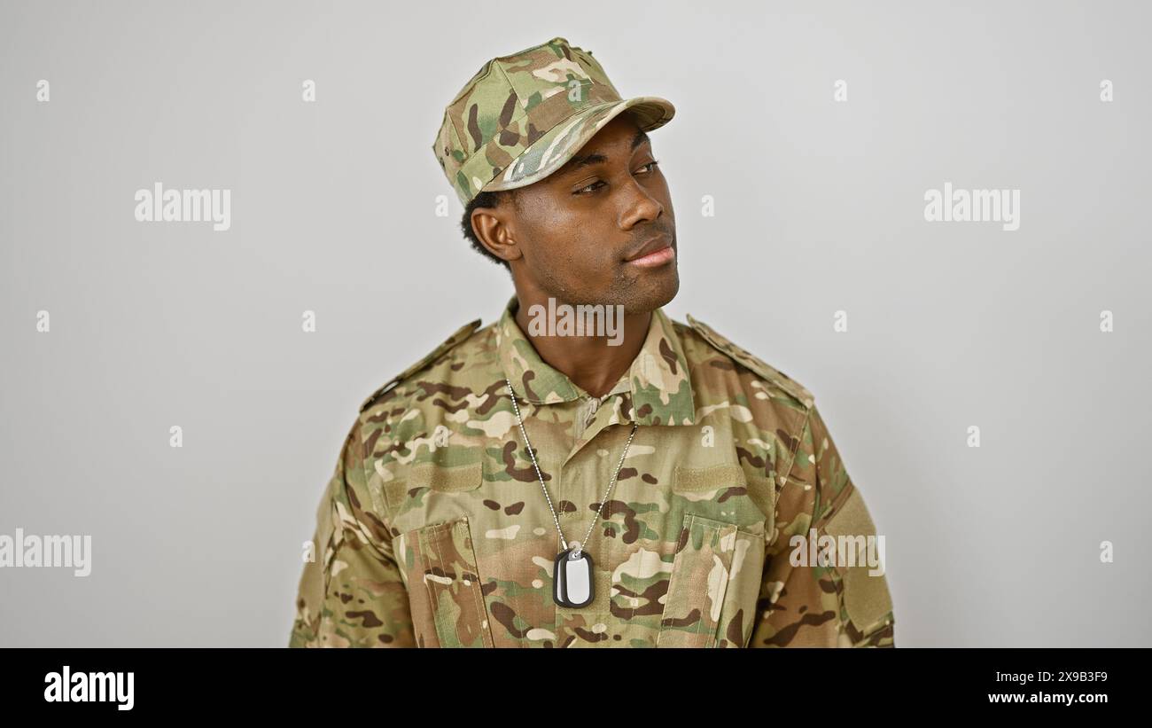 An african american soldier in camouflage uniform stands against a ...