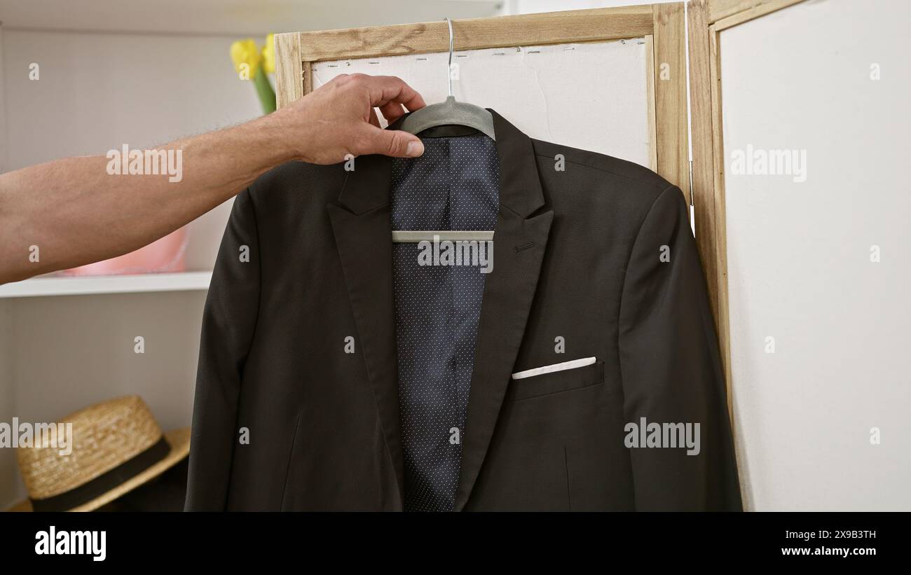 A man selecting a suit in a clothing room, symbolizing mature fashion ...