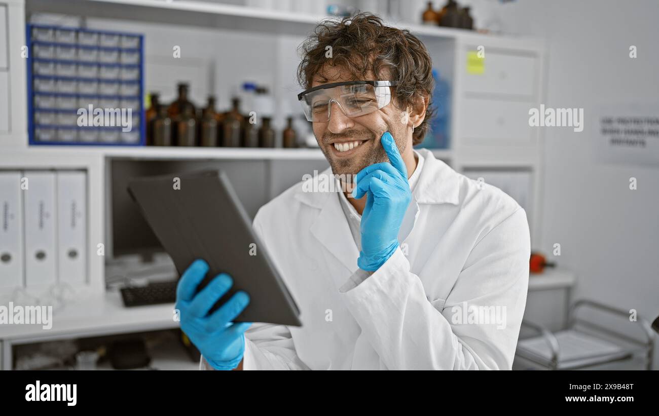 Handsome hispanic man with beard and green eyes smiling in a laboratory ...