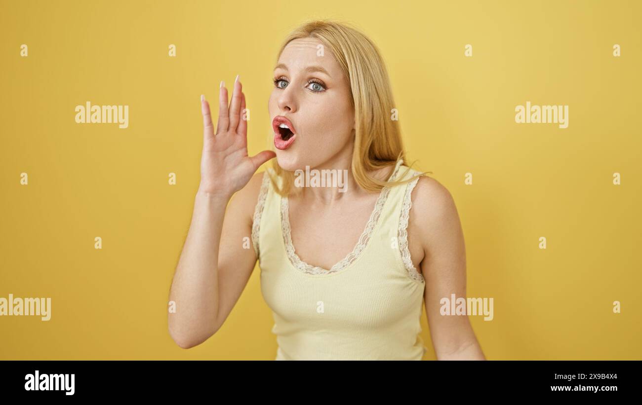 A surprised young woman with blonde hair, shouting over a vivid yellow ...