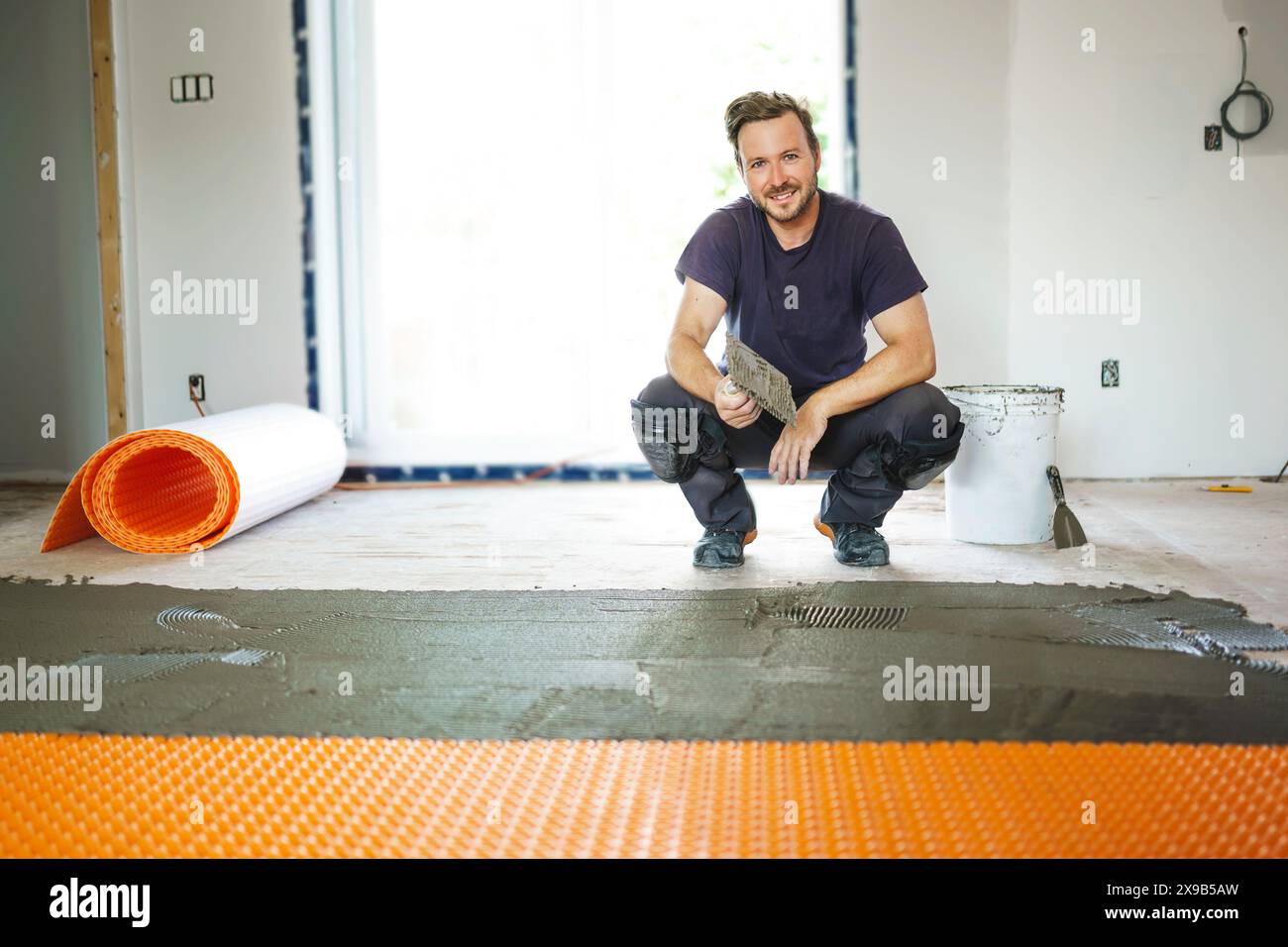 Man worker install orange roll membrane waterproofing on the floor ...