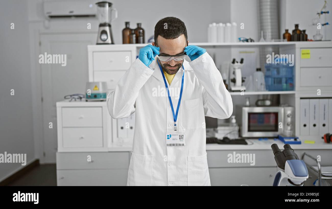 Hispanic scientist in lab coat adjusting safety goggles in a modern ...