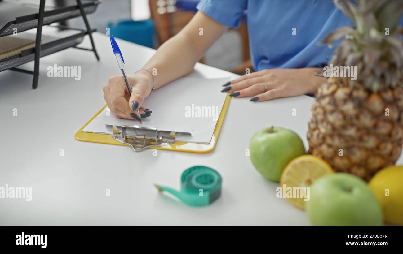 A caucasian dietitian writing a nutrition plan in a clinic, surrounded ...