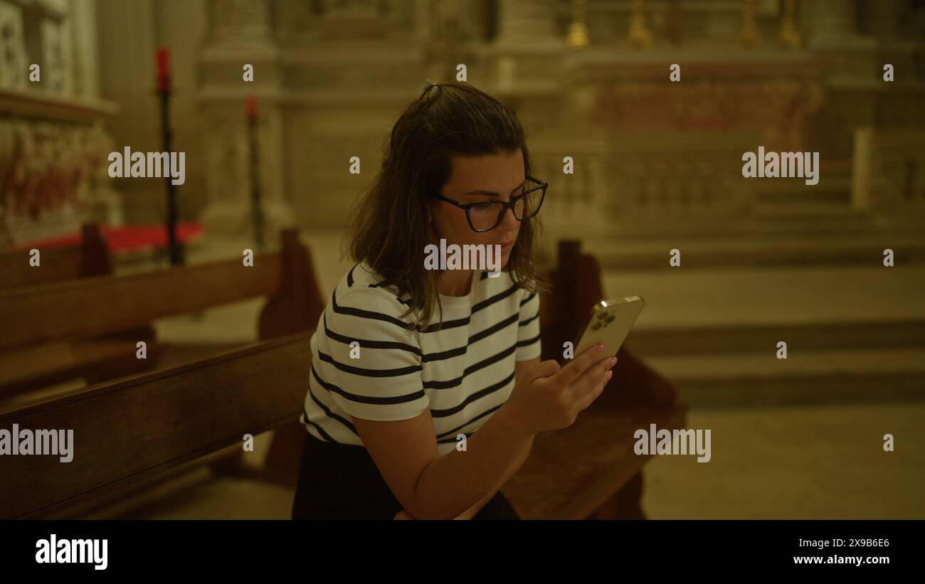 Young hispanic woman using a smartphone inside a christian church in ...