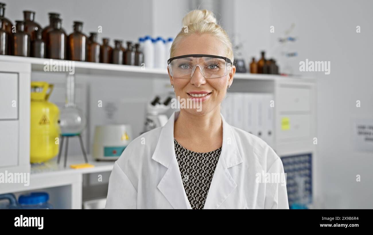 Joyful young blonde woman scientist, full of confidence, smiling under ...