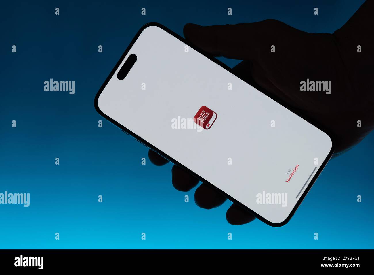 New York, USA - May 6, 2024: Open Holy Bible app on smartphone in hand ...