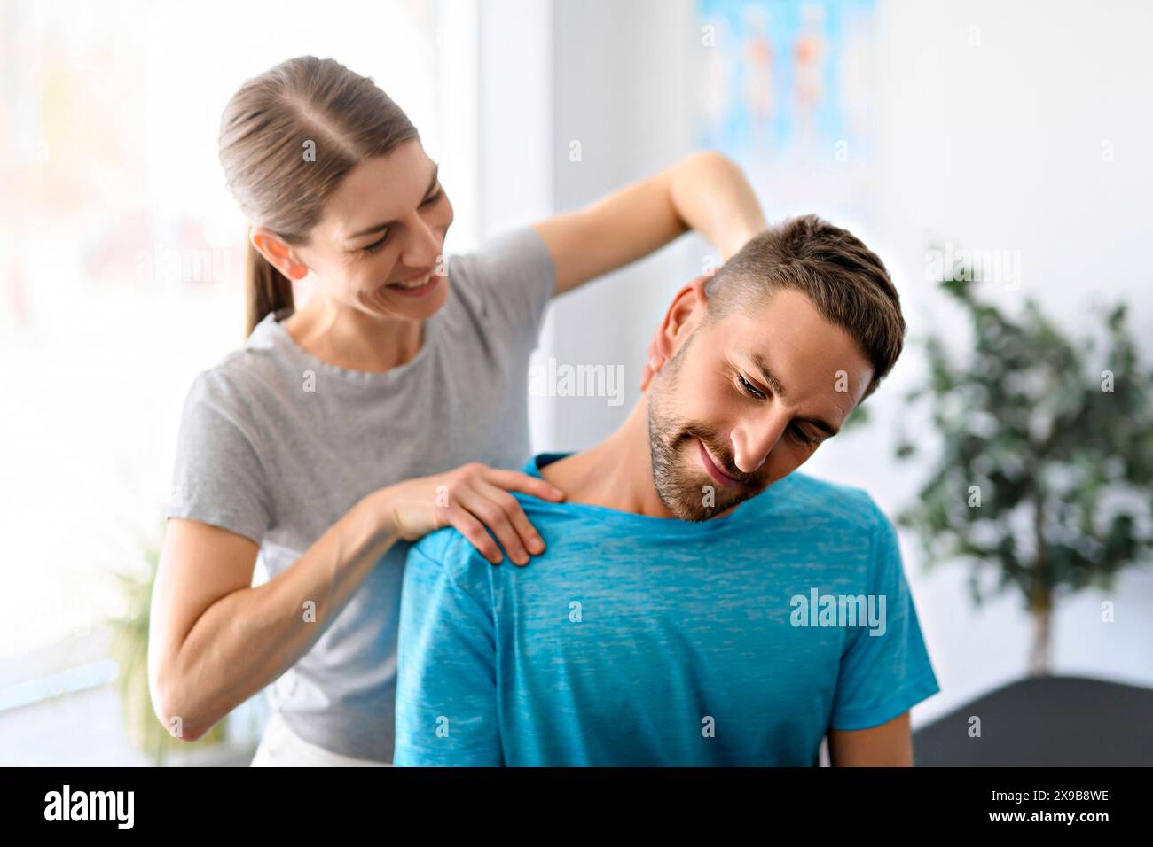Modern rehabilitation physiotherapy woman worker with man client neck ...