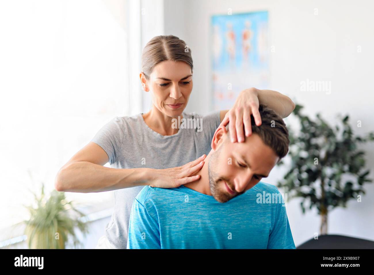 Modern rehabilitation physiotherapy woman worker with man client neck ...