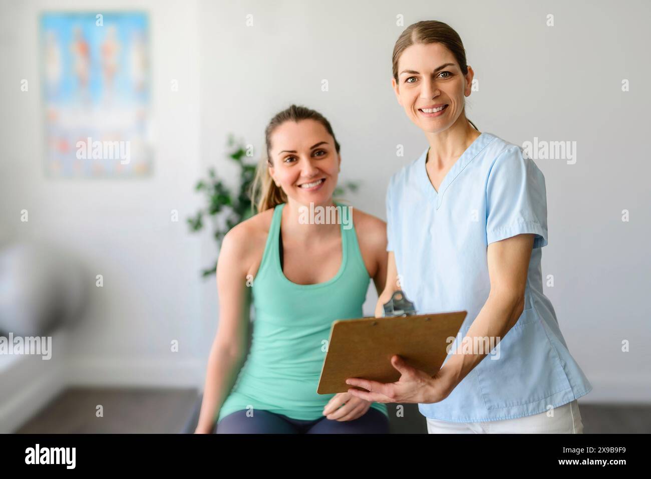 Modern rehabilitation physiotherapy woman worker with woman client ...