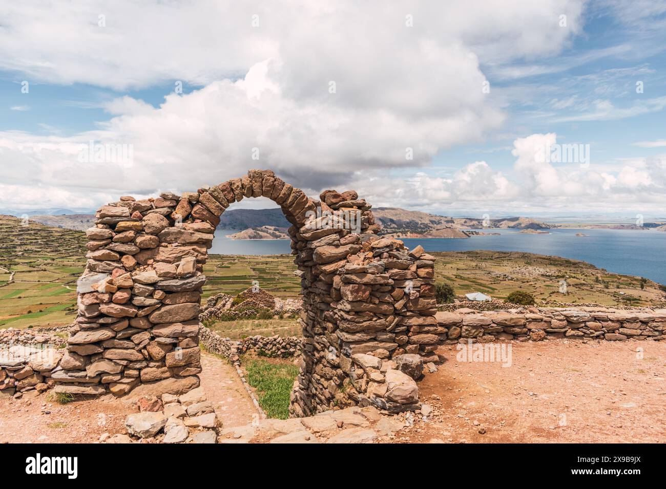 stone arch on top of a mountain on the island of amantani in puno peru ...