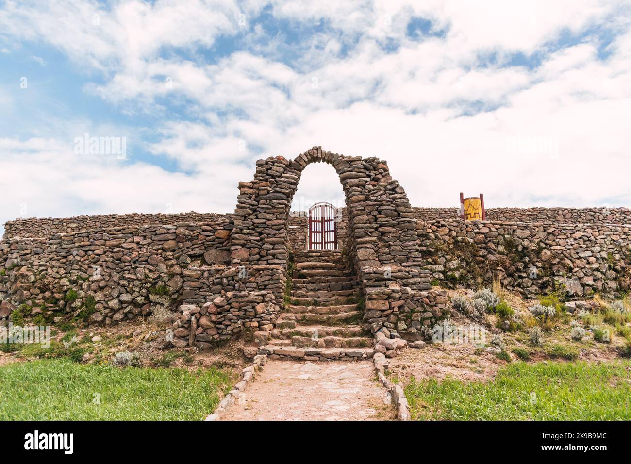 stone arch on top of a mountain on the island of amantani in puno peru ...