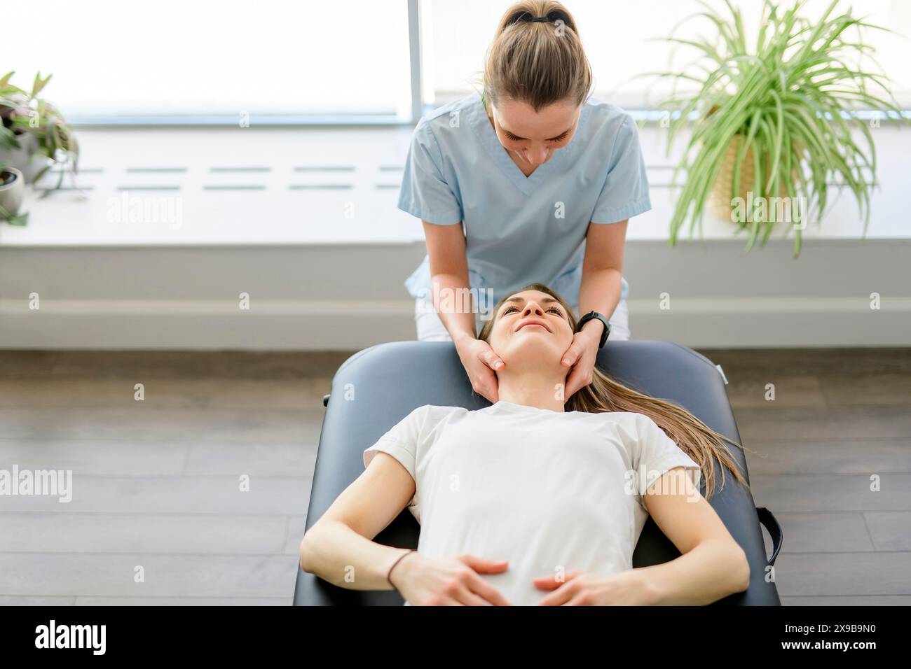 Modern rehabilitation physiotherapy woman worker with woman client ...