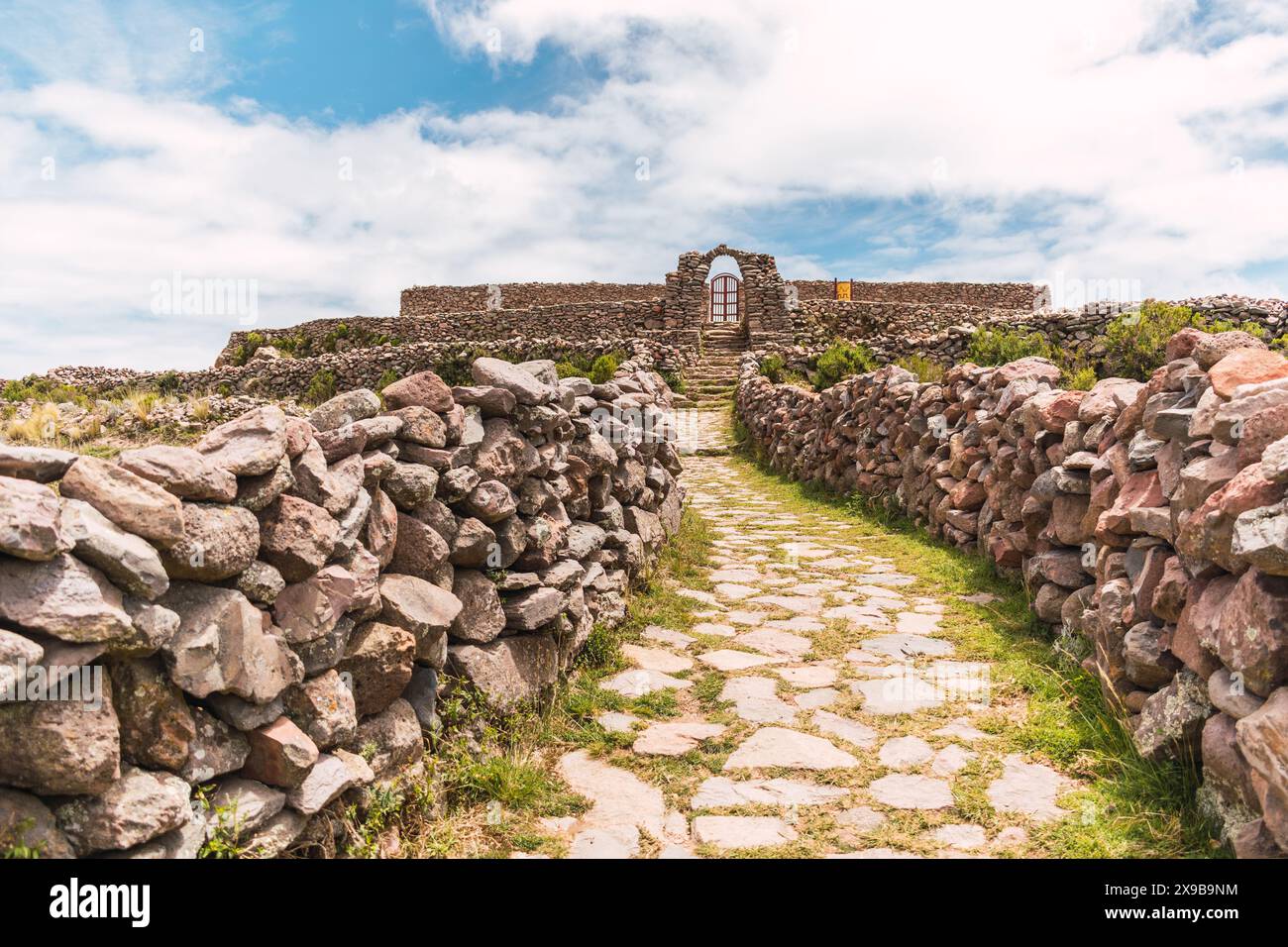 stone arch on top of a mountain on the island of amantani in puno peru ...