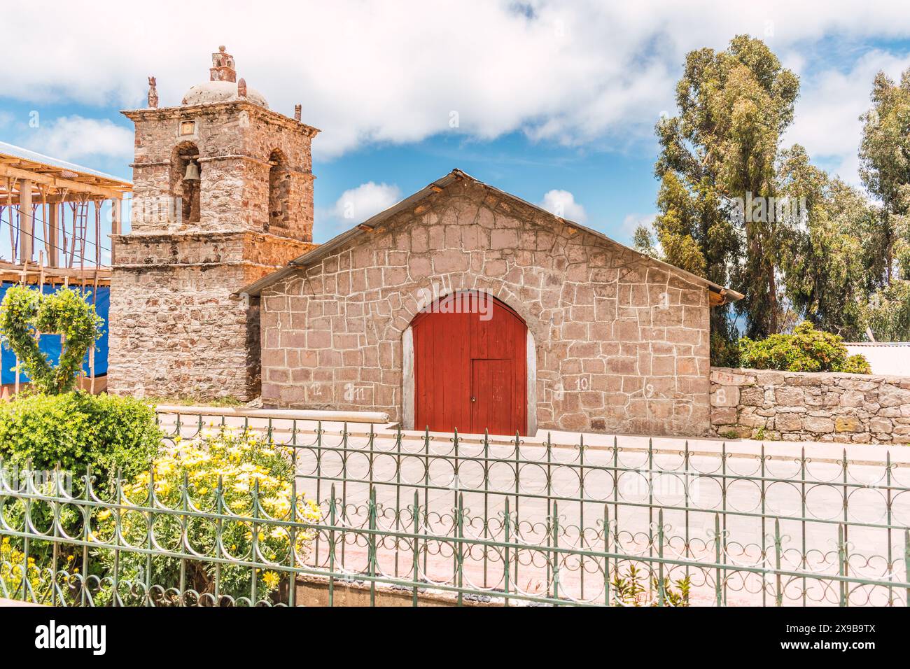 church with bell tower in the plaza de amantani on lake titicaca in ...
