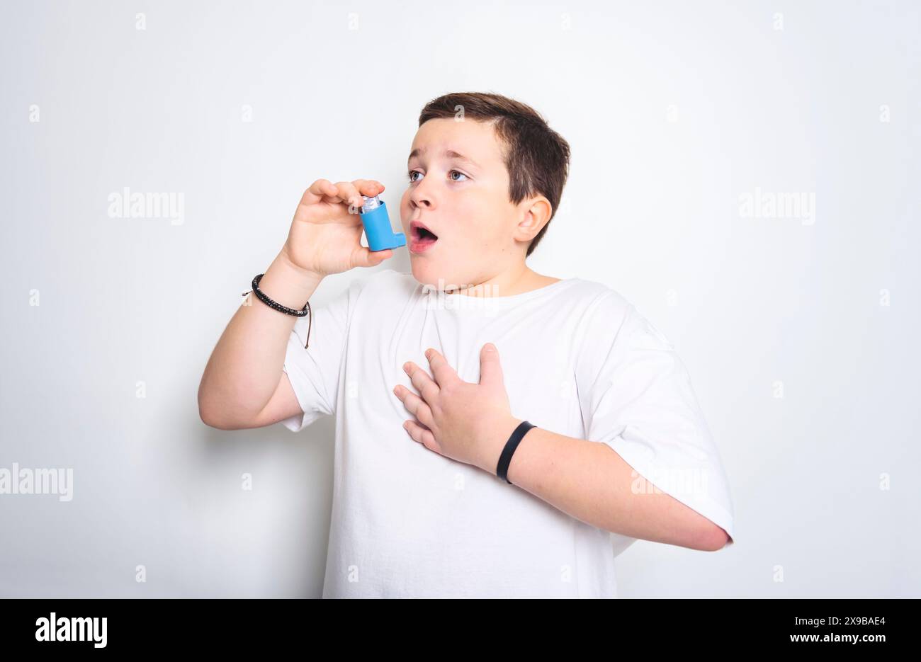 child using inhaler for asthma over White background studio Stock Photo ...