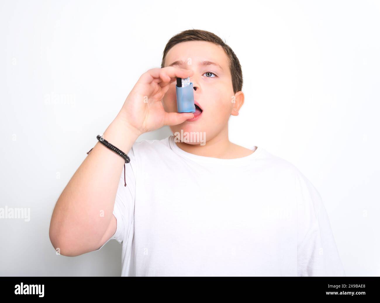 child using inhaler for asthma over White background studio Stock Photo ...