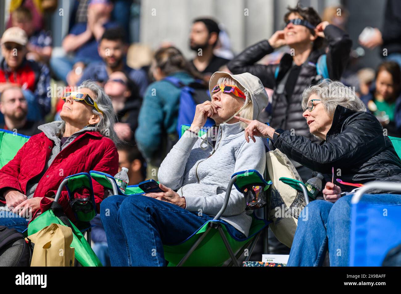 Viewers watch the solar eclipse of 2024 from the lawn of the Vermont ...