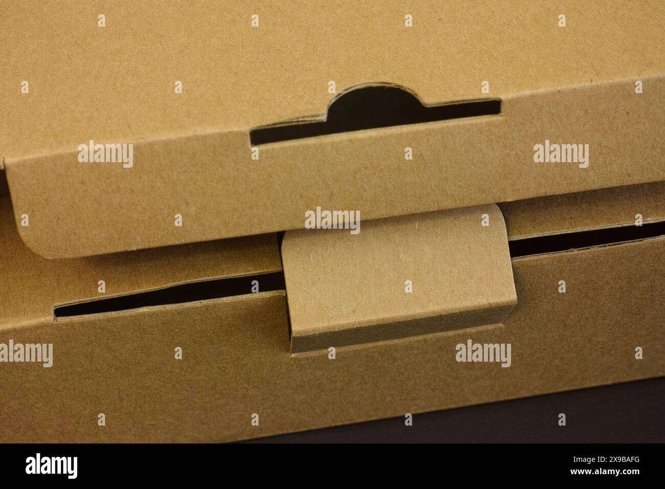 A close-up shot of a clasp on a cardboard box cover Stock Photo - Alamy