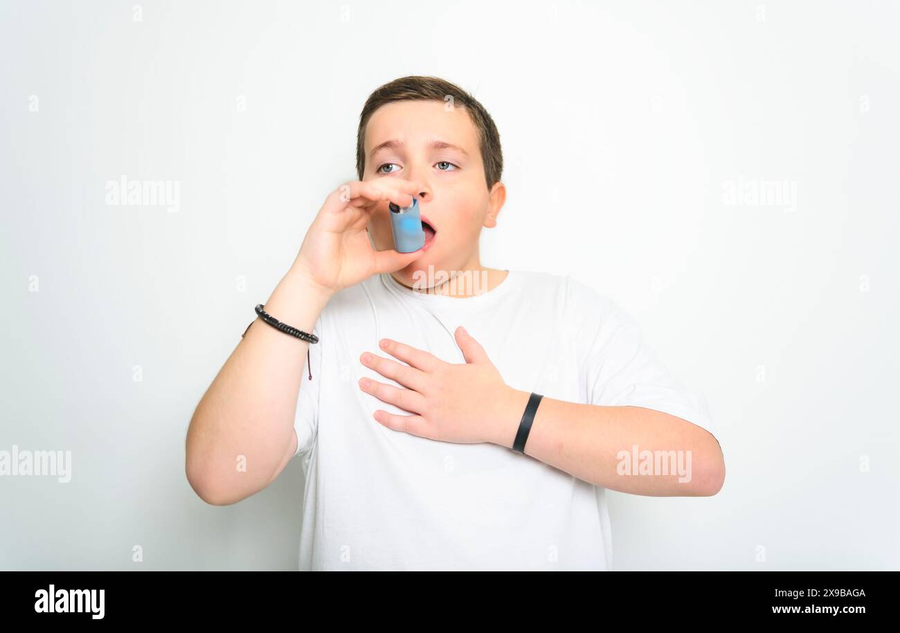 child using inhaler for asthma over White background studio Stock Photo ...
