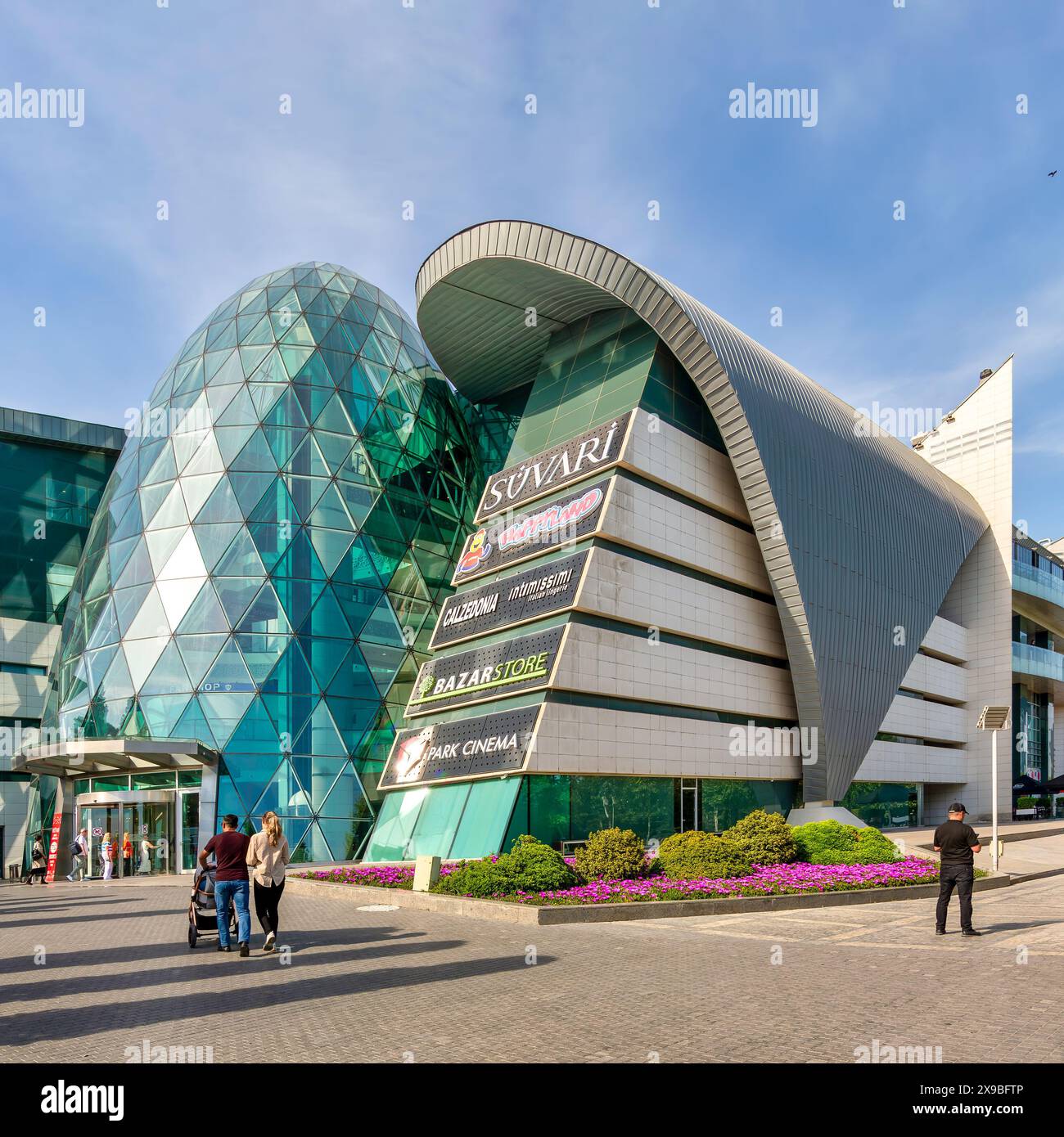 Baku, Azerbaijan - May 10 2024: Few people walk near the modern design ...