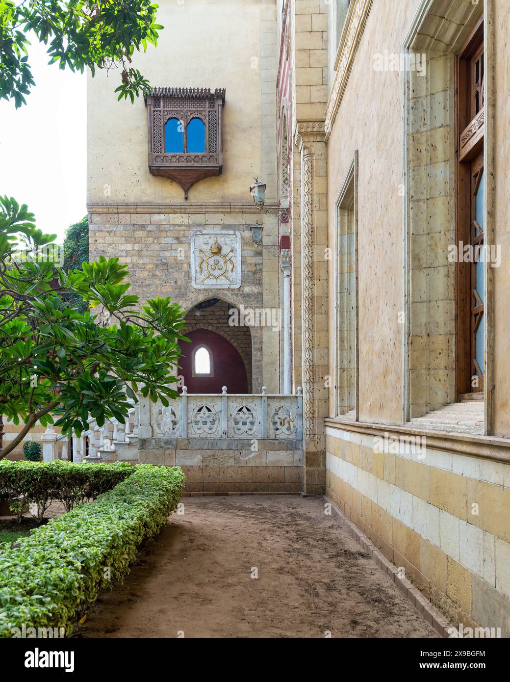A serene view of a rustic style building featuring an arched balcony ...