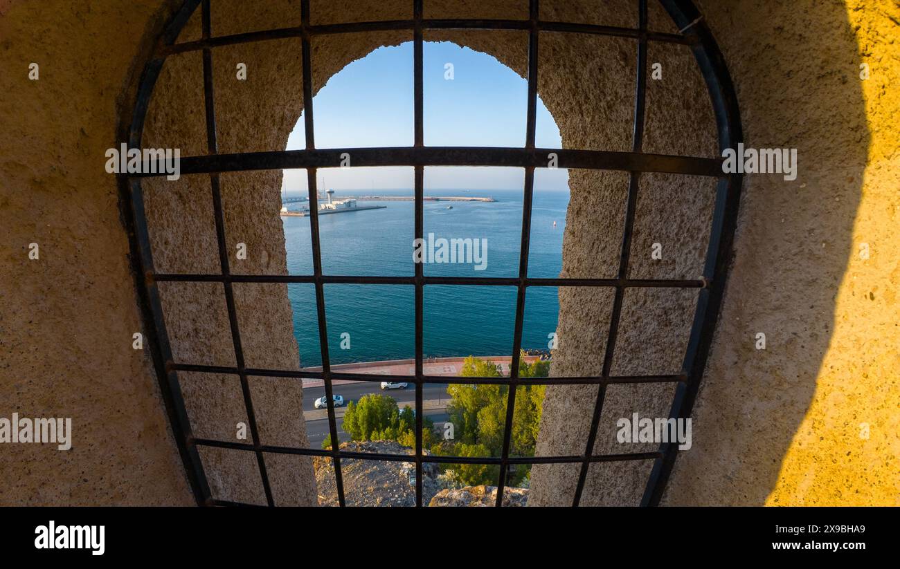 Photography of bay of water in Oman, Muscat old town through a castle ...