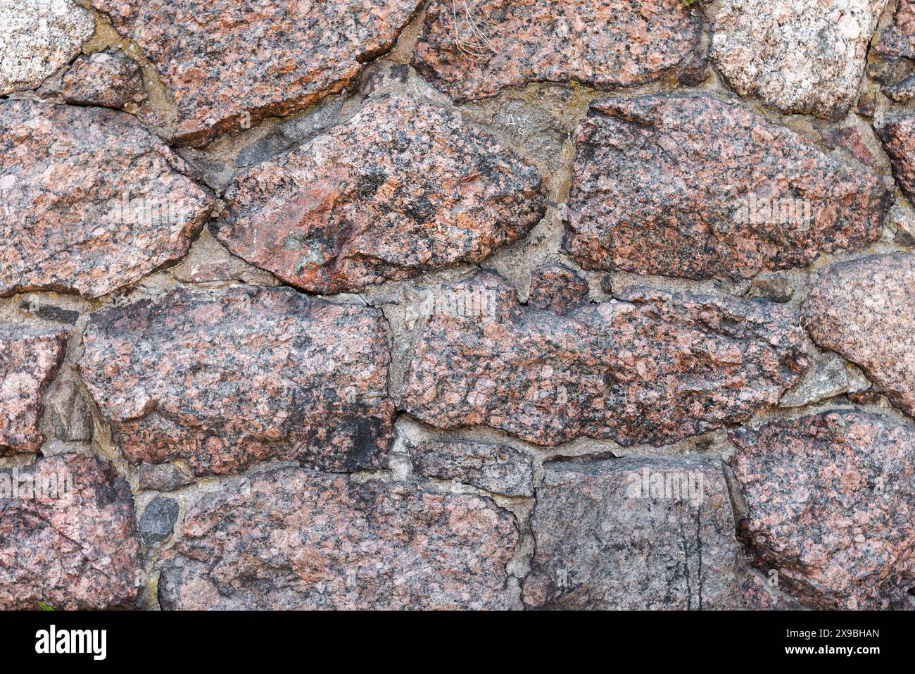 Old stone wall made of massive granite blocks, background photo texture ...