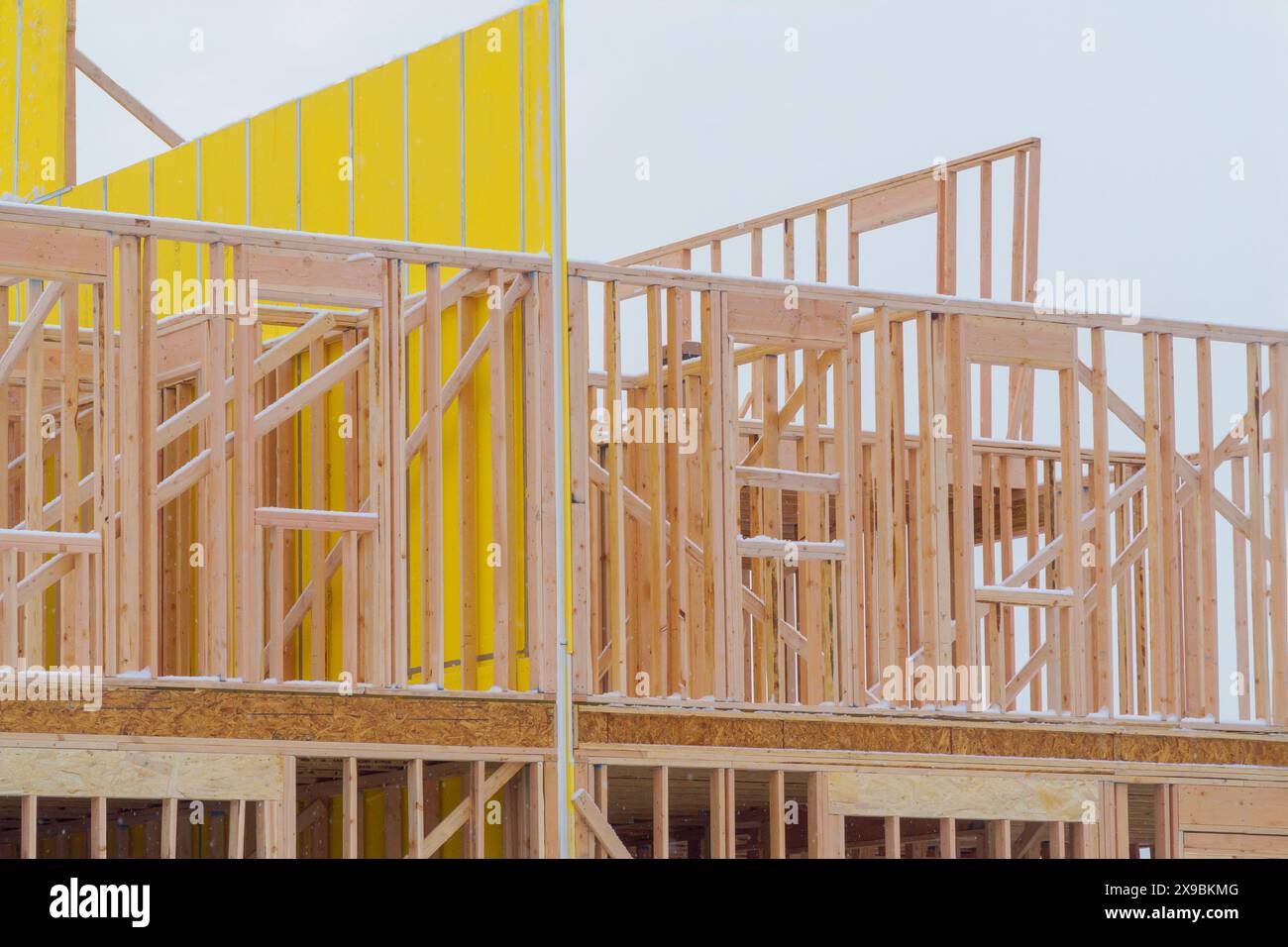 In unfinished interior of newly built house, timber studs support beam ...