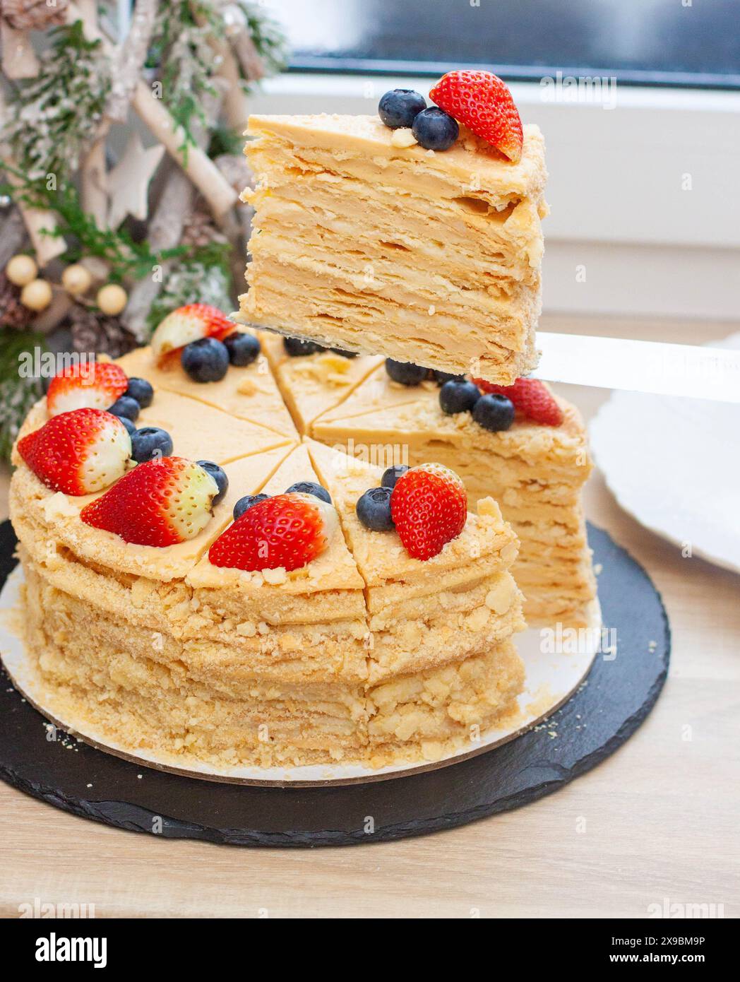Napoleon cake decorated with fresh berries and fruits. Delicious ...