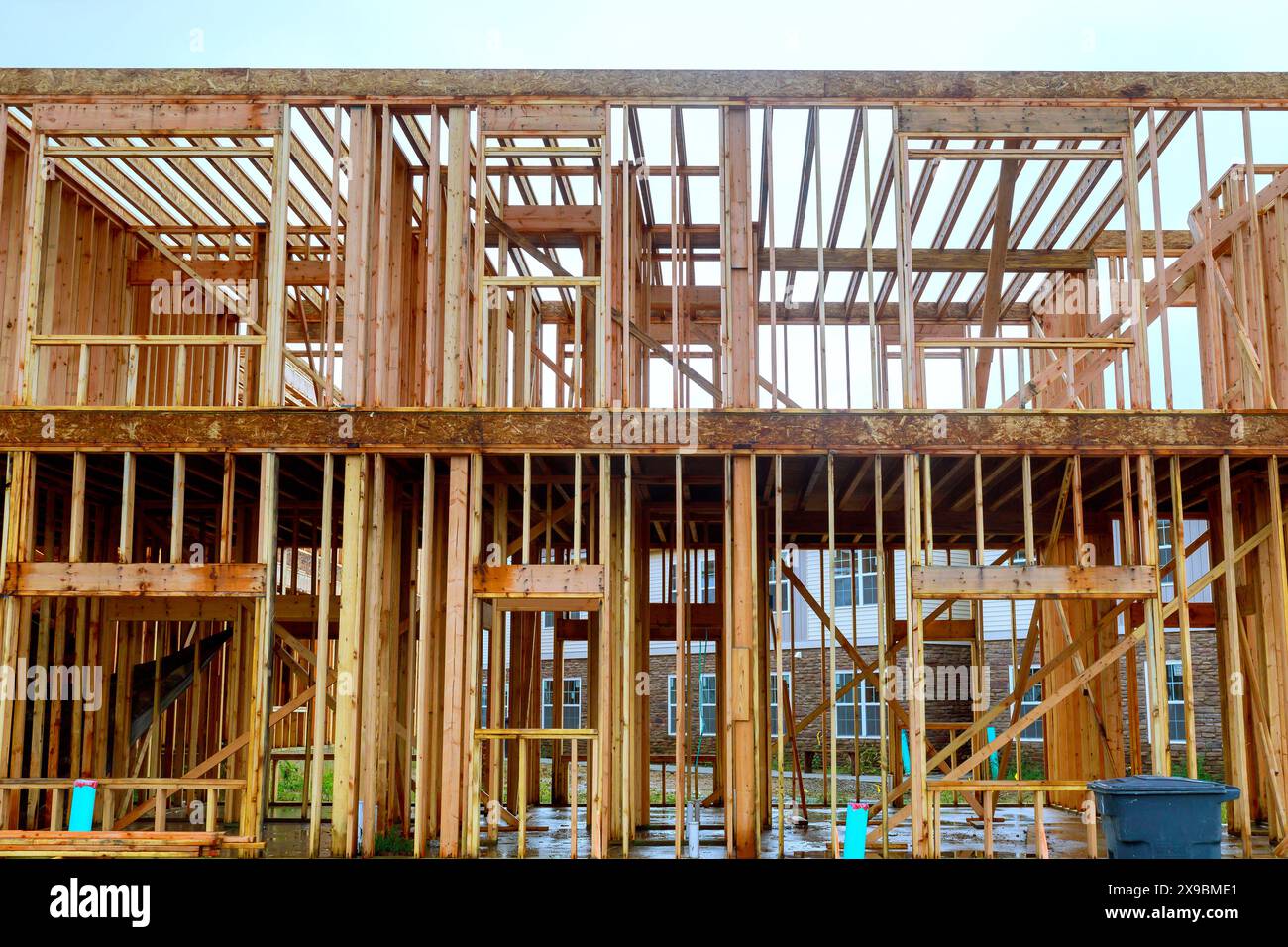 An unfinished interior of newly built house with wooden stud timber ...