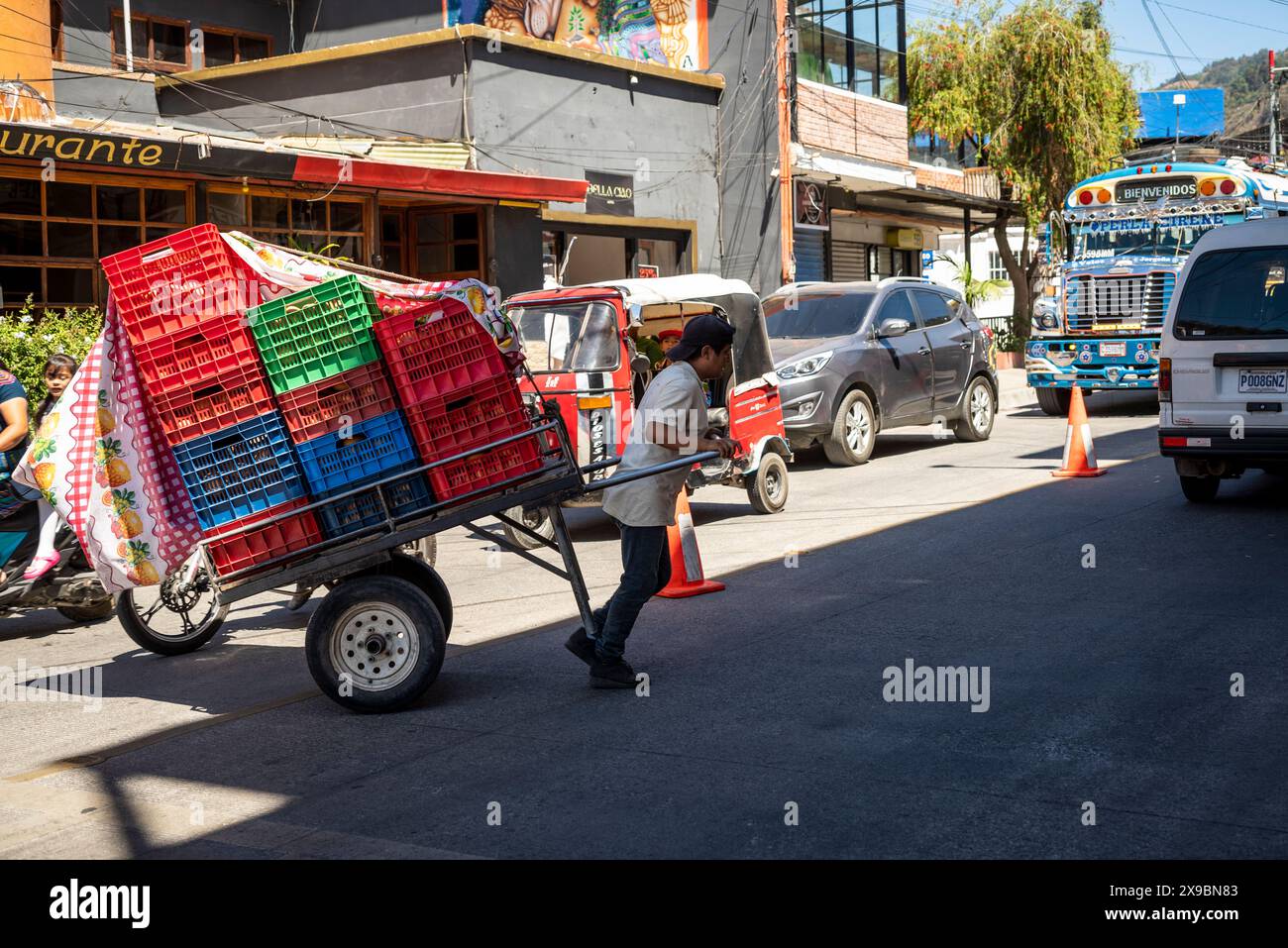 Man pulling a hand-cart full of crates, Panajachel, Lake Atitlan ...