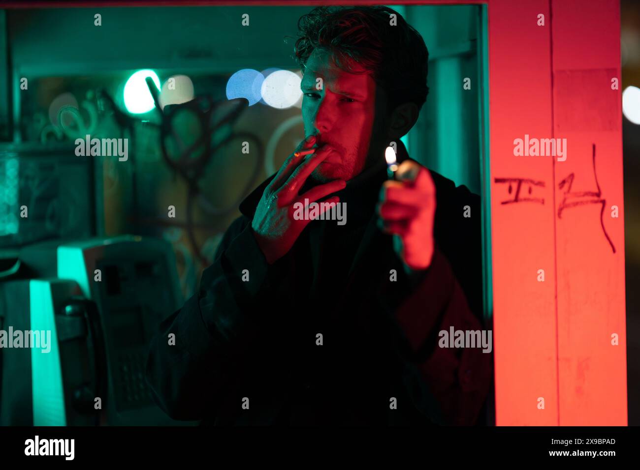A man is smoking a cigarette in a telephone booth Stock Photo - Alamy