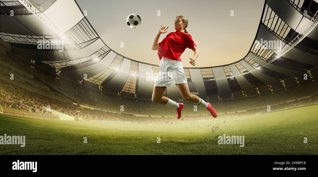 Dynamic image of competitive young woman, soccer player on field during ...