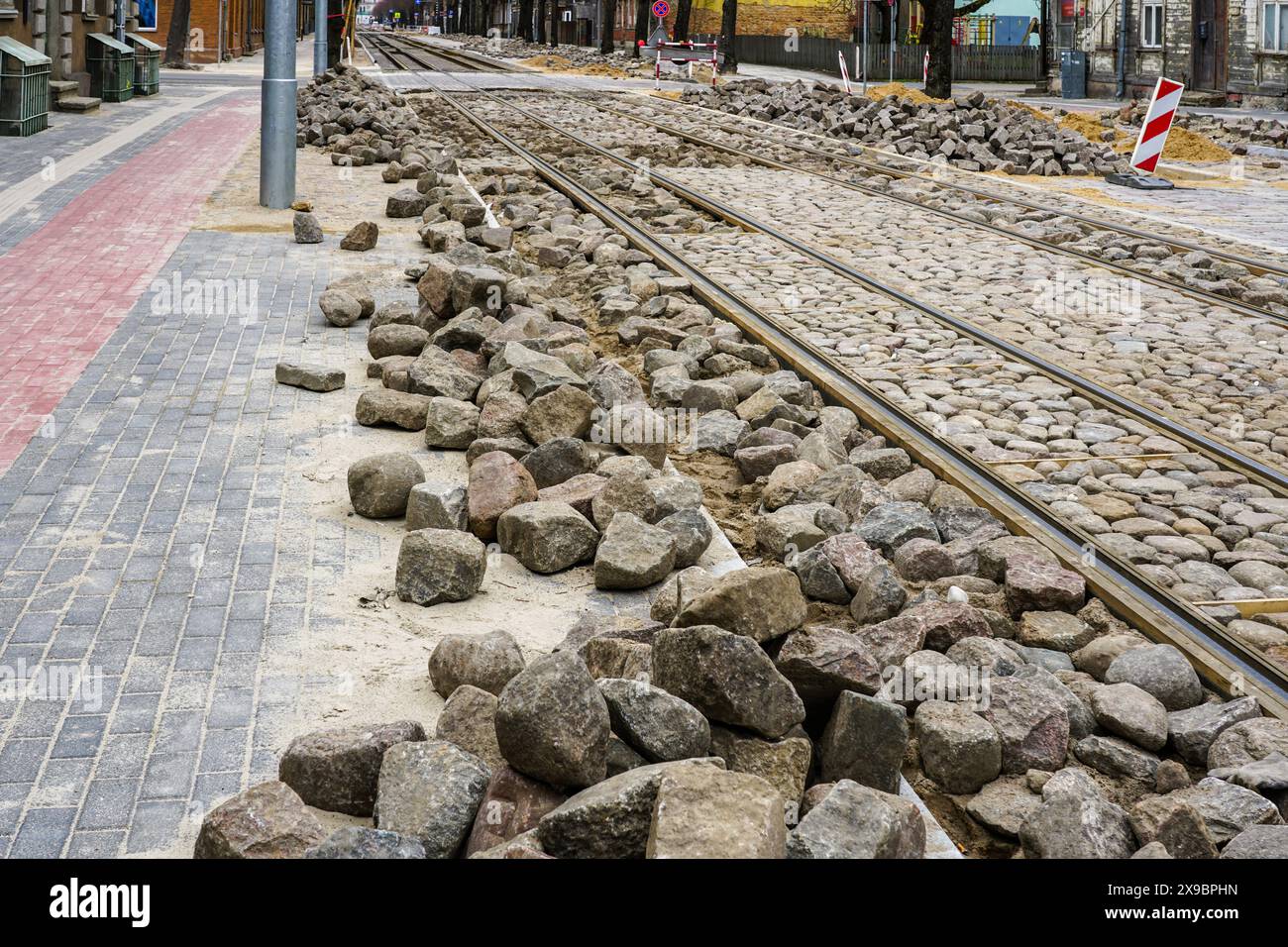 Paving of the tram tracks and street with historic natural granite ...