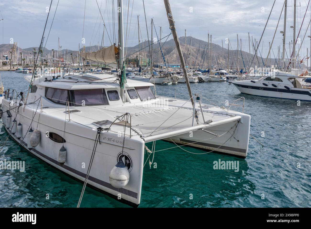 Catamaran tied at the Yacht Port Cartagena dock, a sports port with the ...