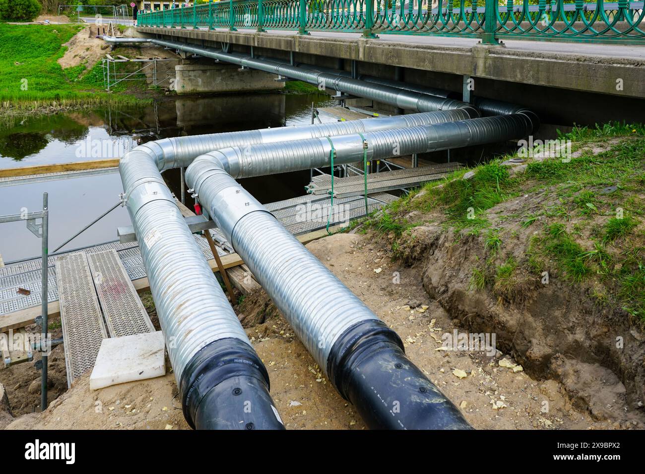 Installation of a new modern winding heating pipeline in a galvanized ...