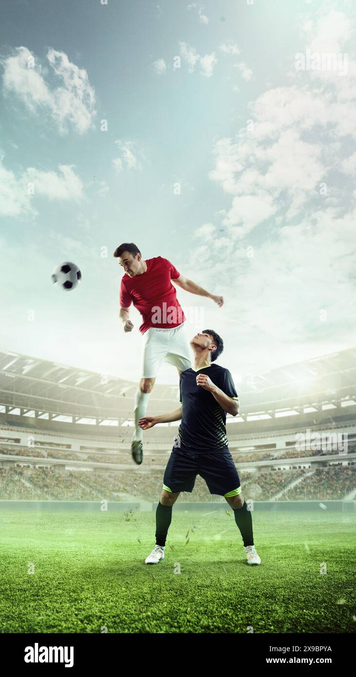 Vertical image of two men, soccer players, opponents on field competing ...