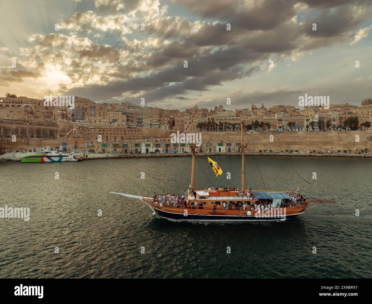 Sightseeing cruise boat goes to the harbor. Aerial cityscape about the ...