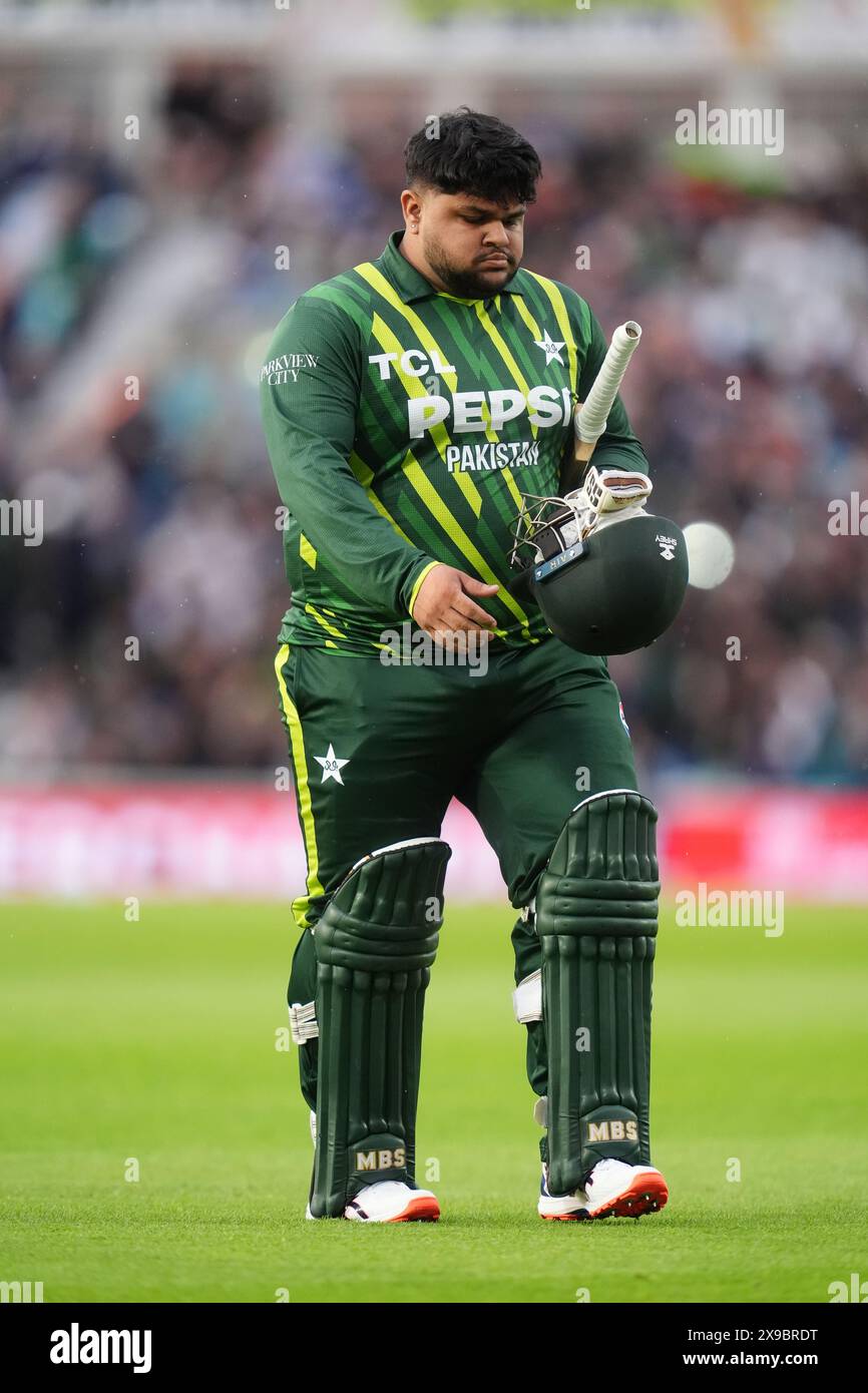 Pakistan’s Azam Khan walks back to the changing rooms after losing his ...